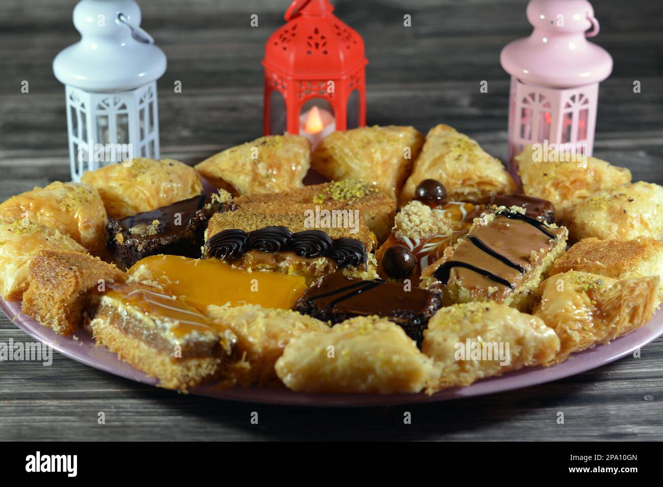 Eastern desserts with Ramadan lanterns, Konafa covered with mango ...