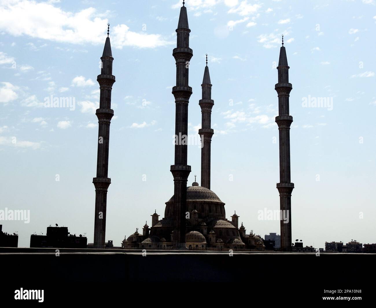 A grand mosque with multiple minarets and domes of different sizes and ...