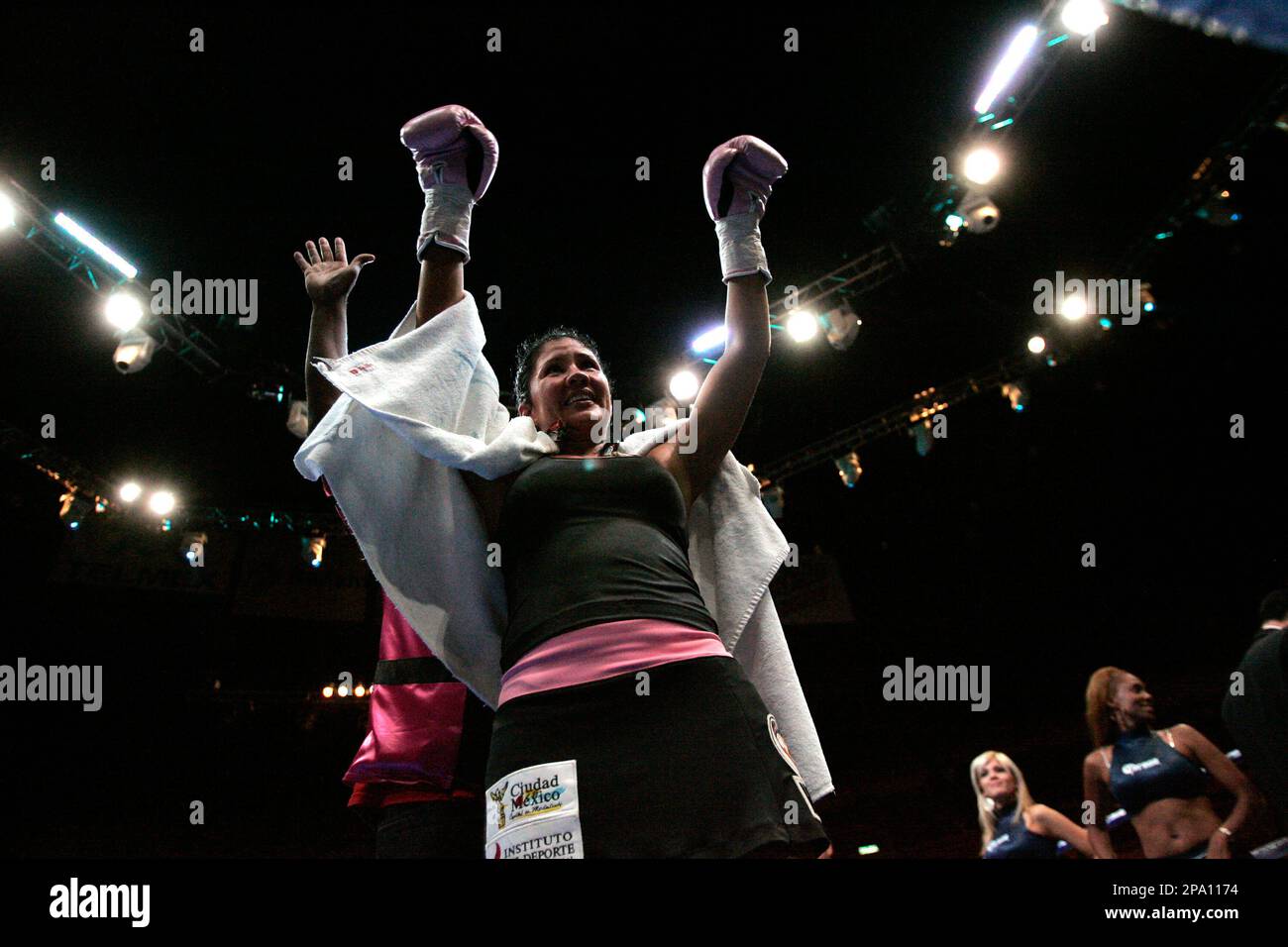 Mia St. John raises her gloves after beating Amy Yuratovac during their ...