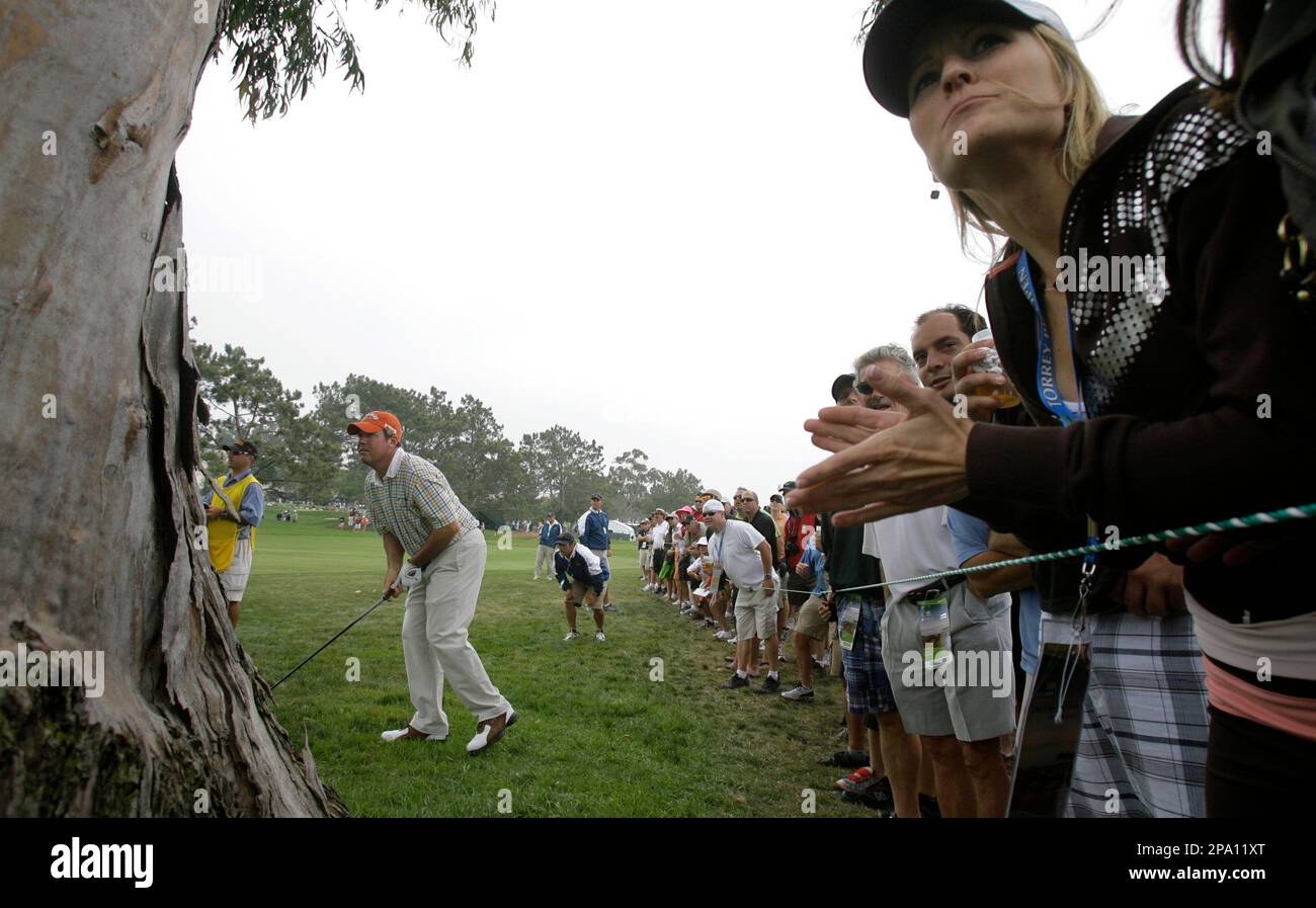 Rich Beem, left, and the gallery watch his shot out of the rough on the ...
