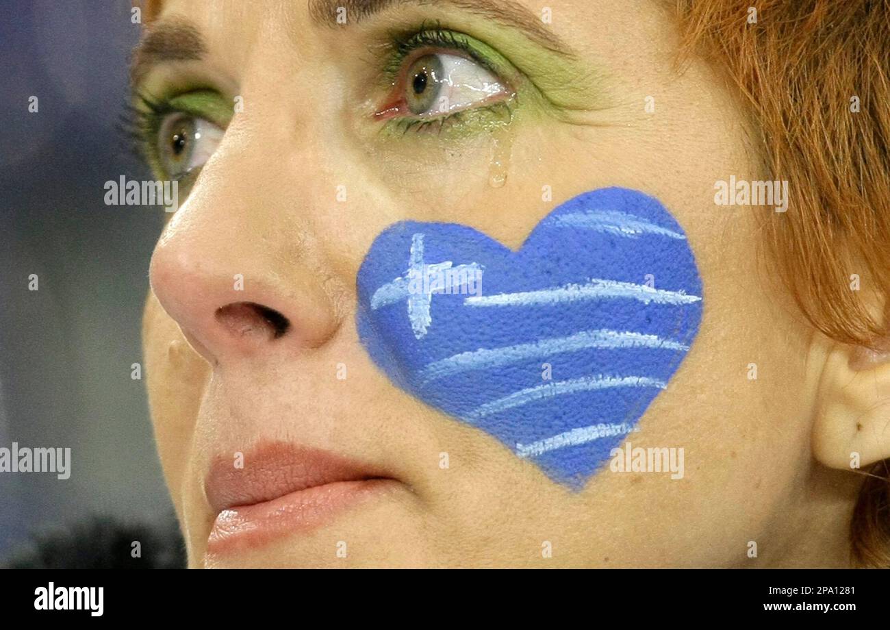A Greek fan reacts after losing 0-1 after the group D match between ...