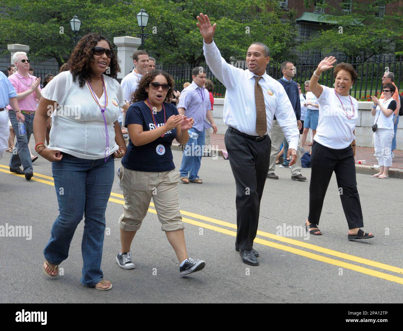 Gov. Deval Patrick, third from left, waves as he walks with his family ...