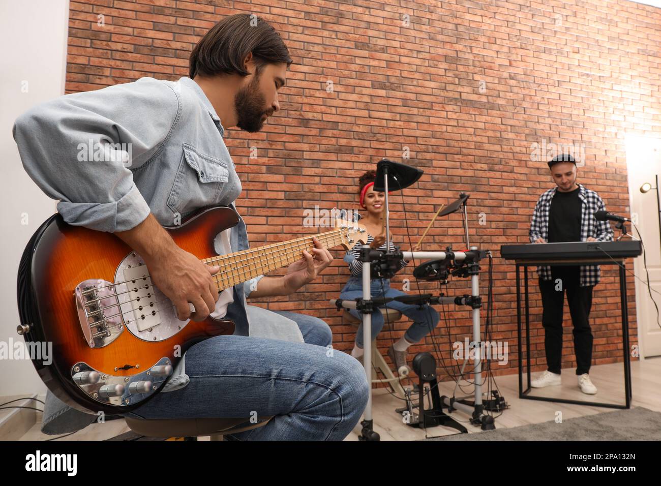 Music band performing in modern recording studio Stock Photo - Alamy