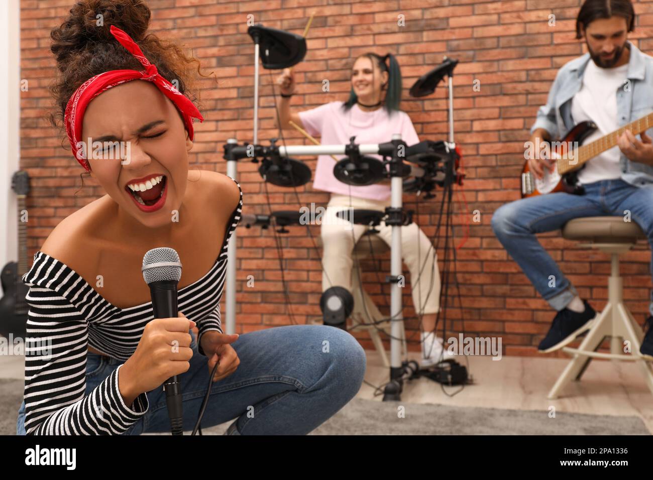 Music band performing in modern recording studio Stock Photo - Alamy