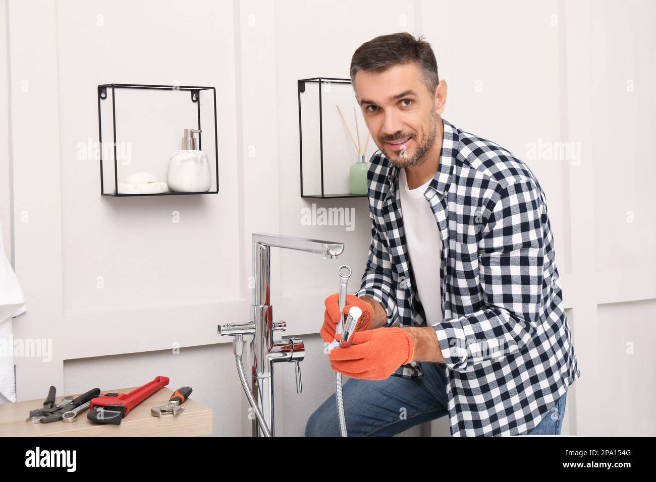 Mature service man installing hi-res stock photography and images - Alamy