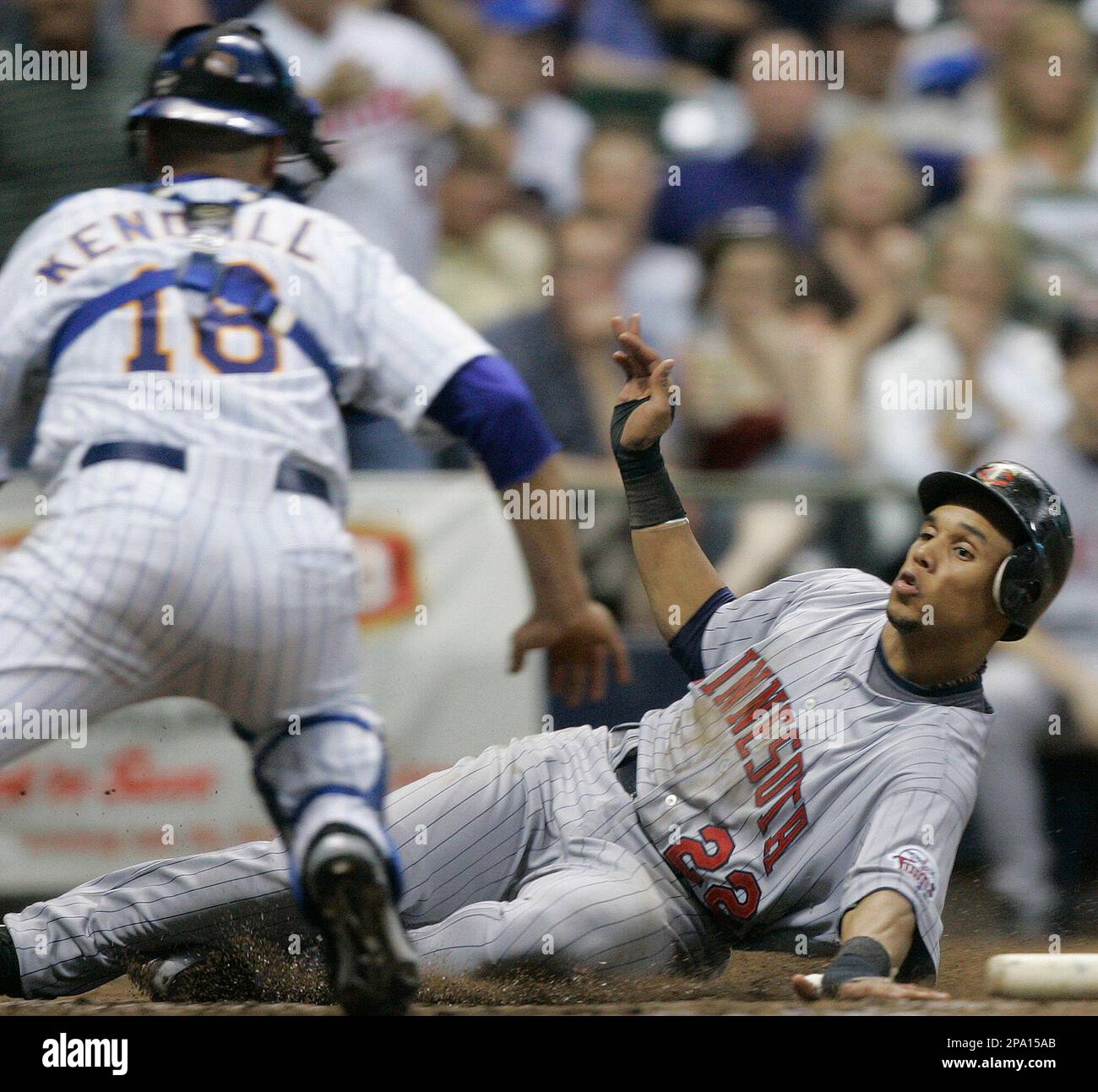 Minnesota Twins' Carlos Gomez, right, slides safely past Milwaukee ...