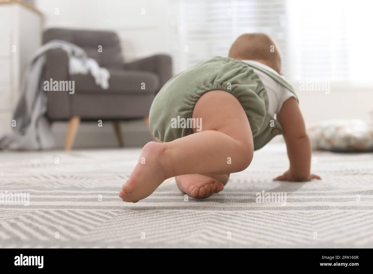 Cute baby crawling at home, focus on legs Stock Photo - Alamy
