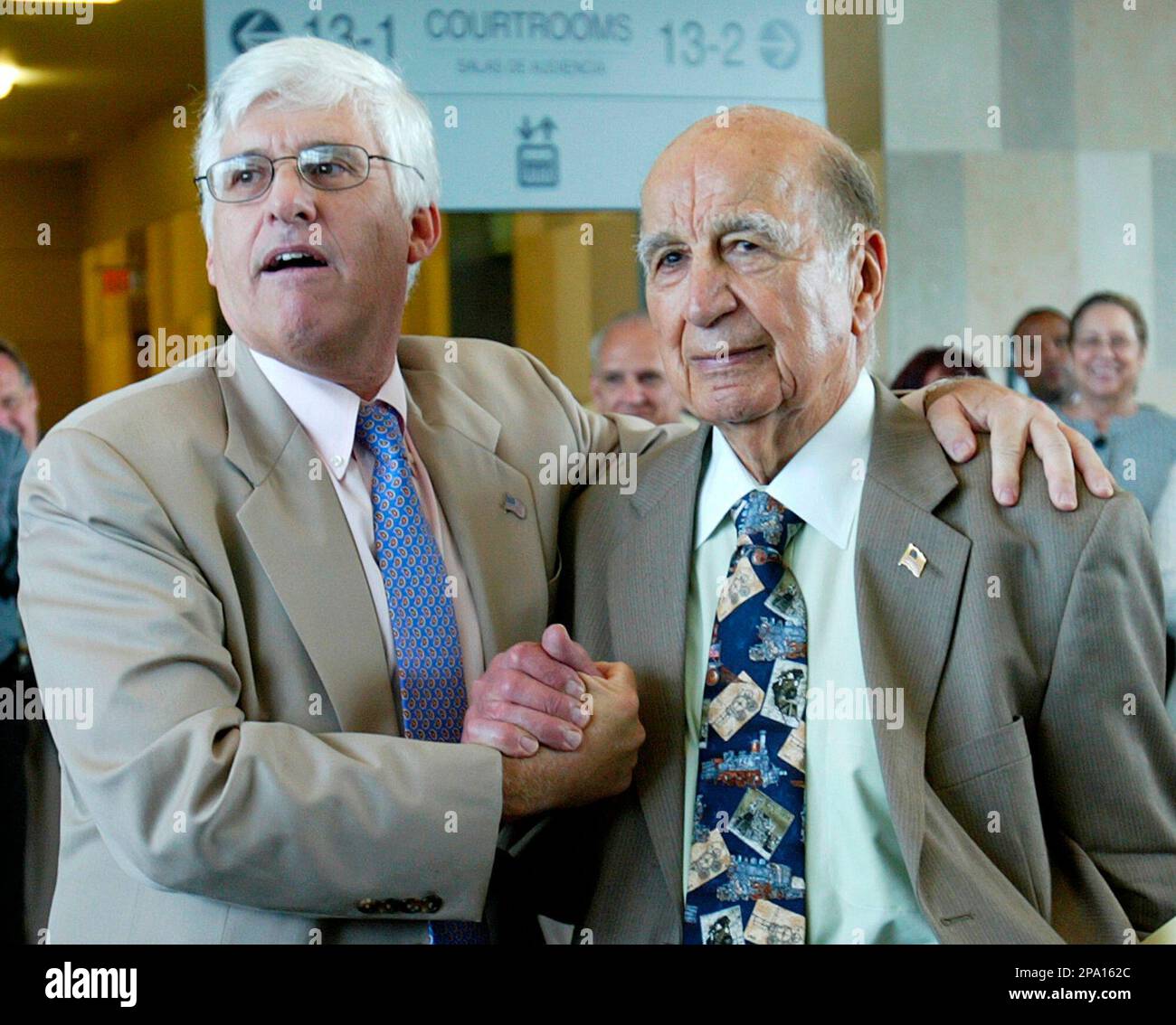 Chief U.S. District Judge Federico A. Moreno, left, hugs Magistrate ...