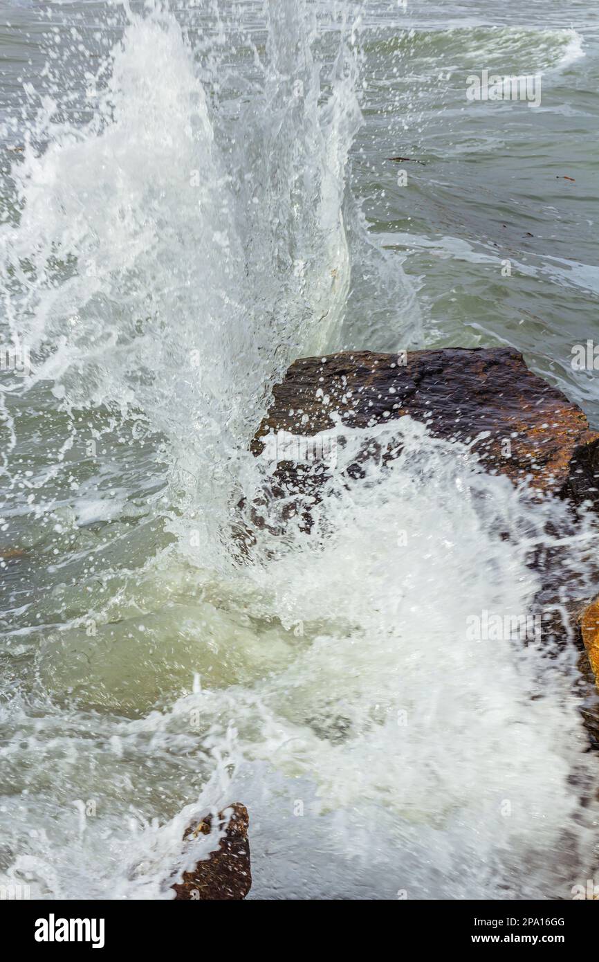 A shot of the sea surf. Splashes of water hitting the stone. Ocean surf ...