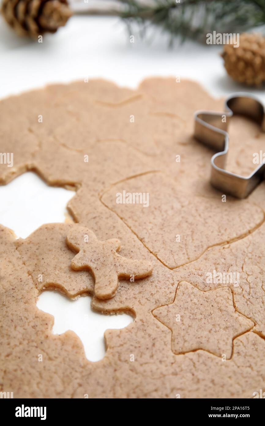 Homemade Christmas biscuits. Raw dough and cookie cutter on white table ...