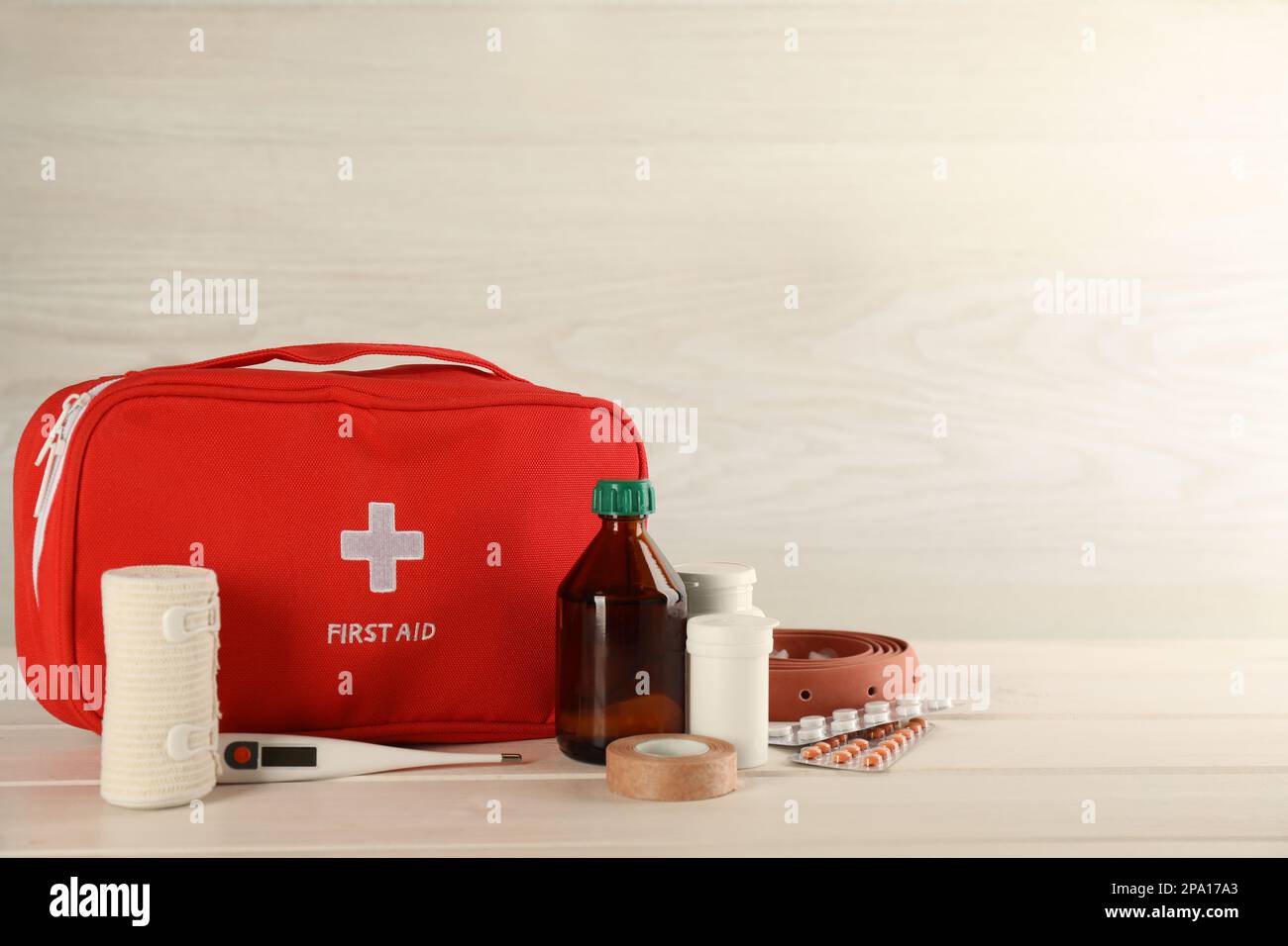 First aid kit on white wooden table, space for text Stock Photo - Alamy