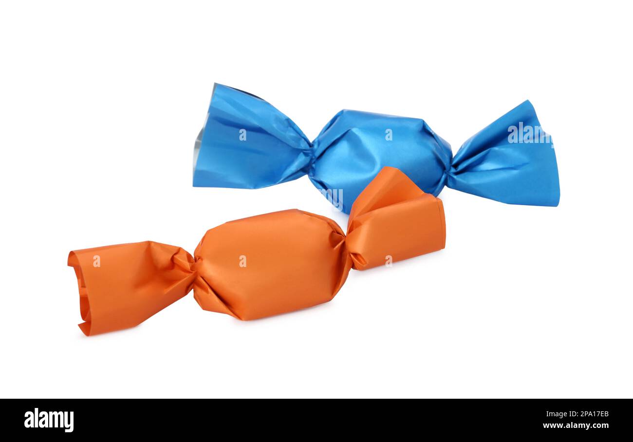 Delicious candies in colorful wrappers on white background Stock Photo ...