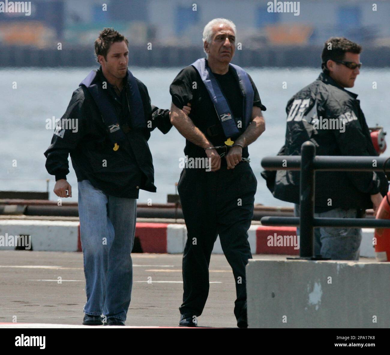 Suspected Syrian arms dealer Monzer al-Kassar, center, is escorted from ...