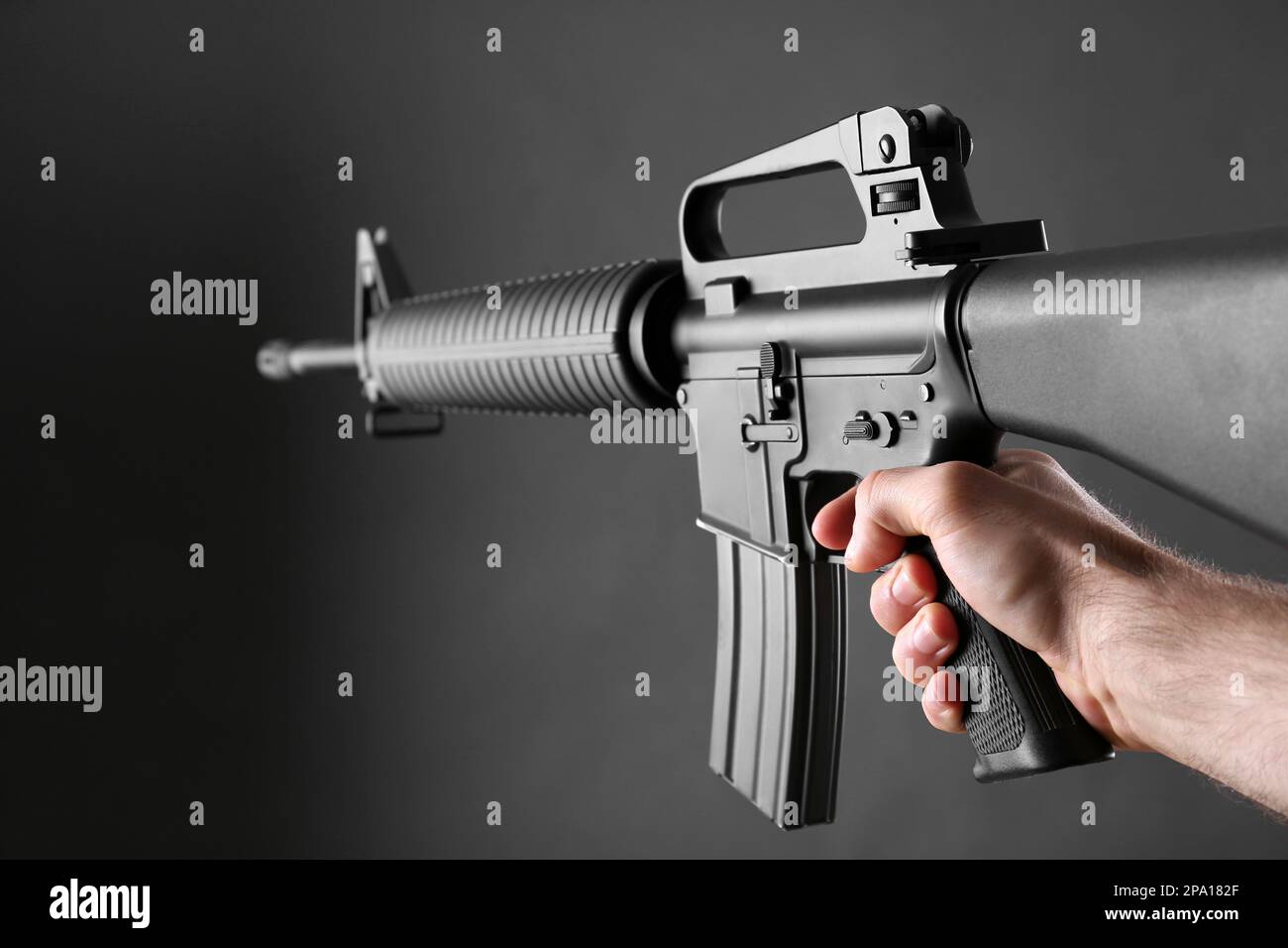 Assault gun. Man aiming rifle on dark background, closeup Stock Photo ...