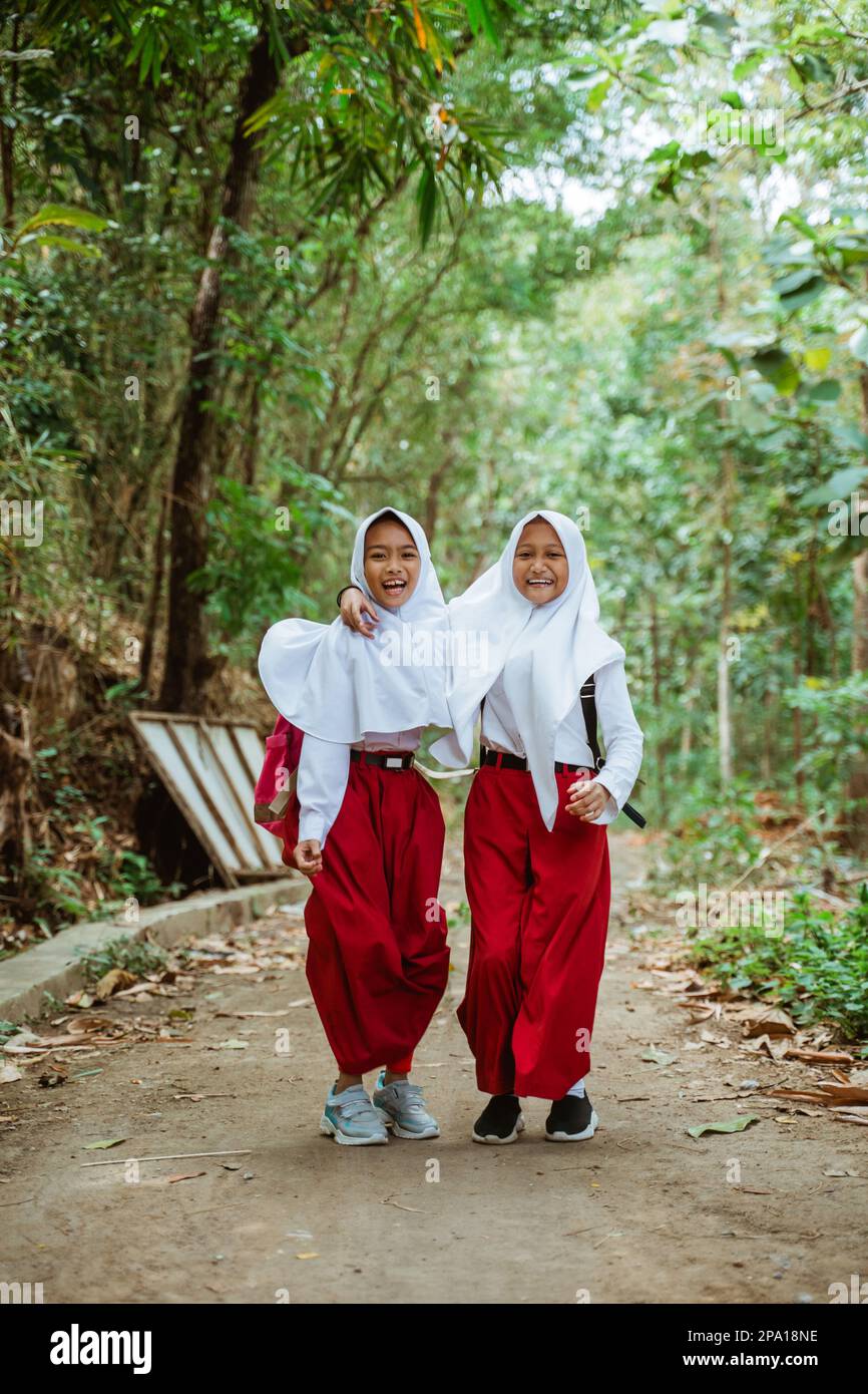 two beautiful student walking together and embracing each othe Stock ...