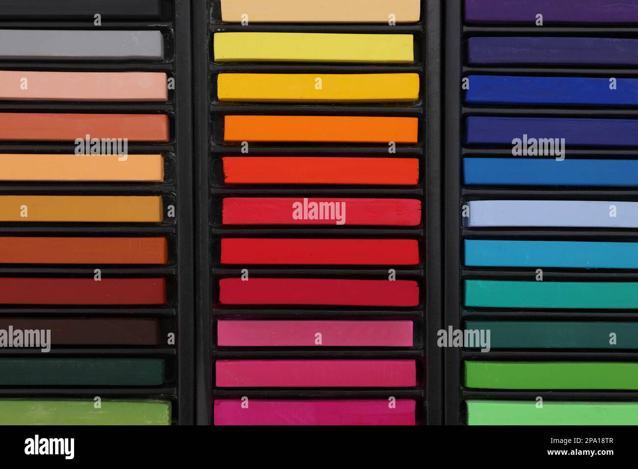 Set of colorful pastels in trays as background, top view. Drawing ...