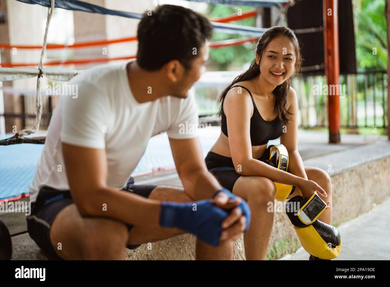 a female boxer and the male boxer sitting and laughing together Stock ...