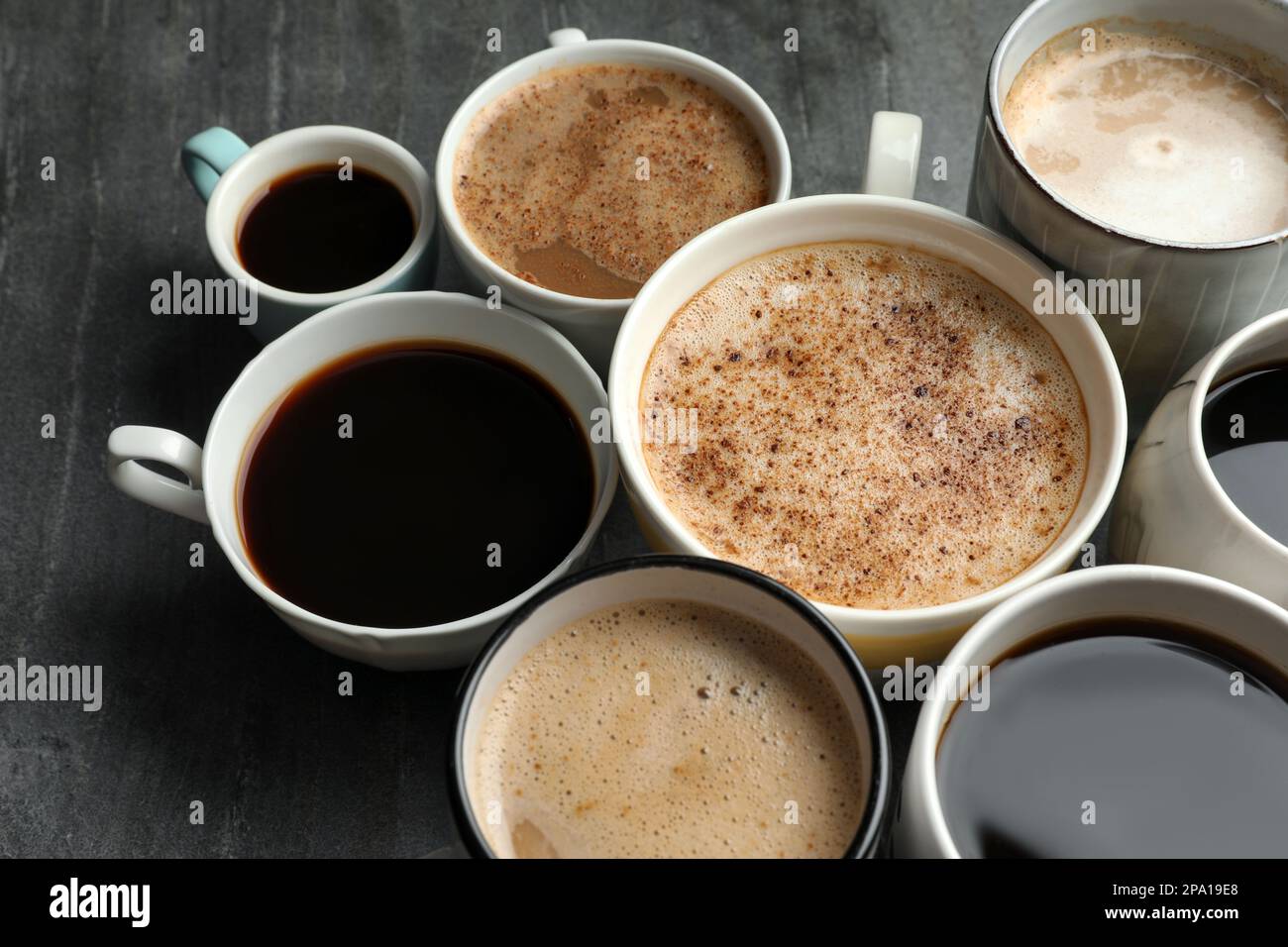 Many cups of different coffees on slate table Stock Photo - Alamy