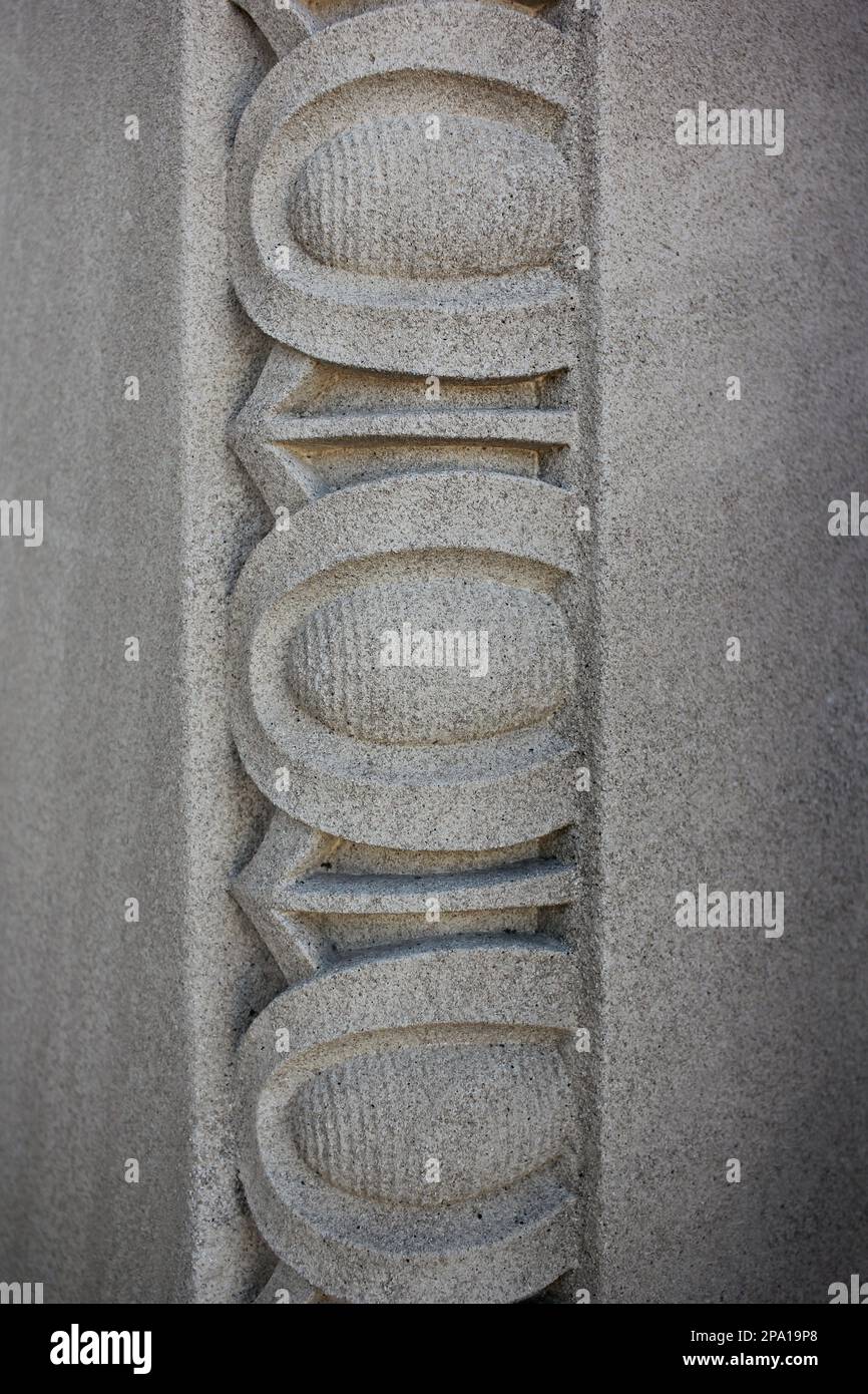 A vintage traditional repeating pattern carved in a natural stone wall ...