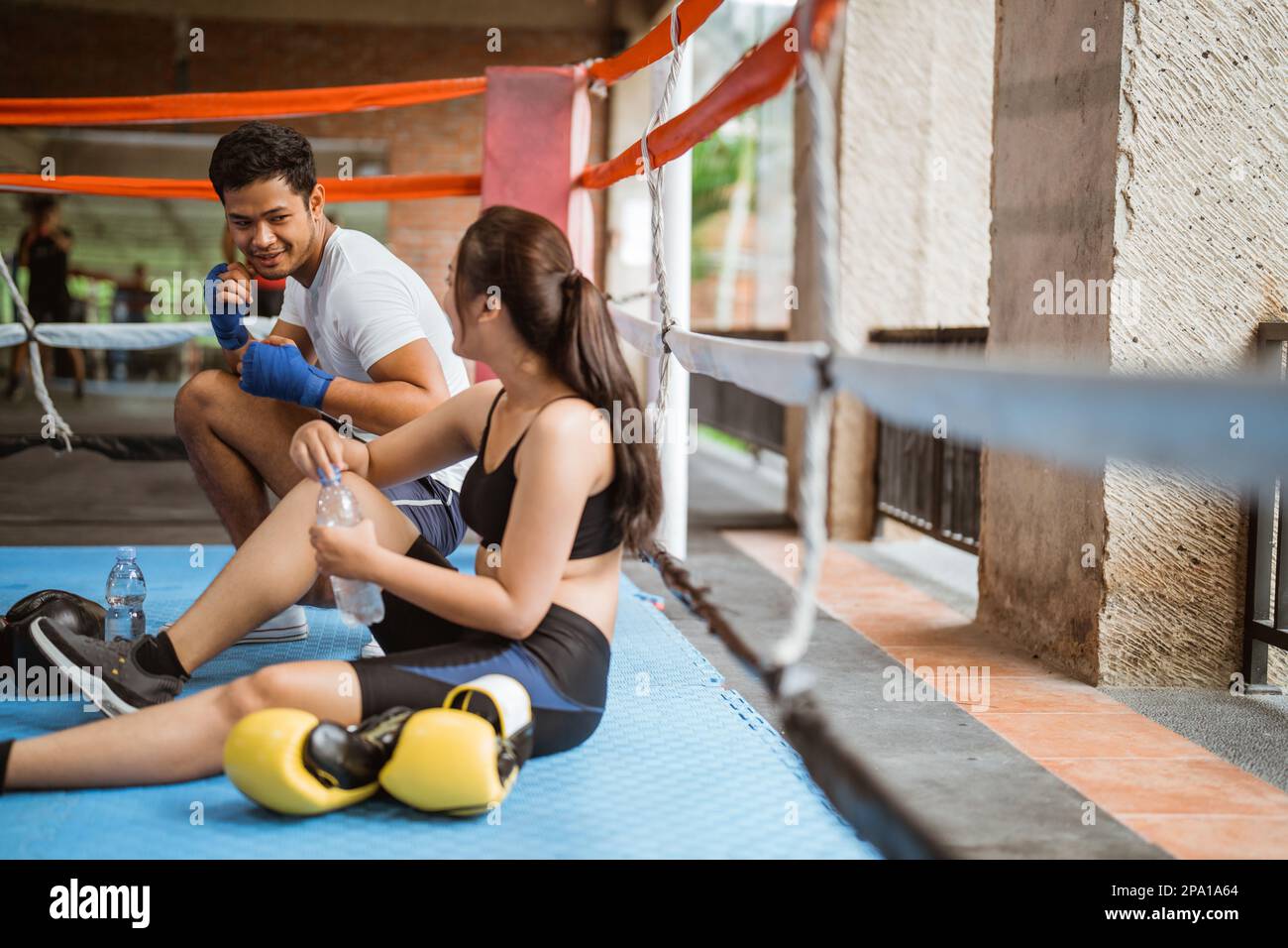 a male boxer doing the boxing move next to the female boxer Stock Photo ...