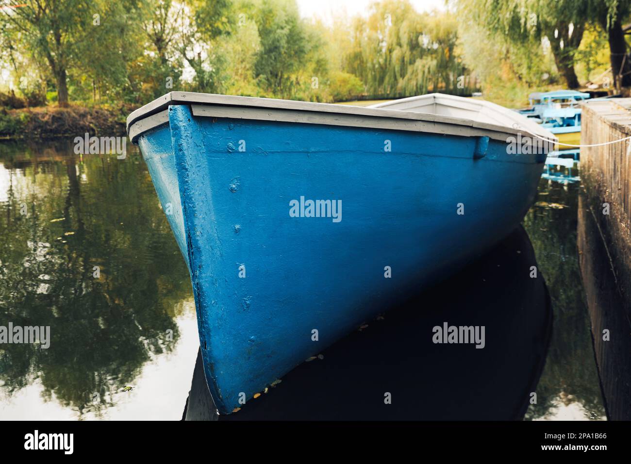 Light blue wooden boat on lake, closeup Stock Photo - Alamy