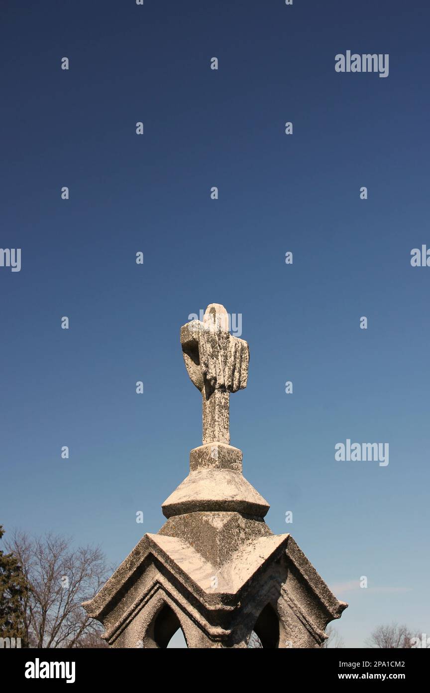 The old stone cross standing tall against the clear blue sky Stock ...