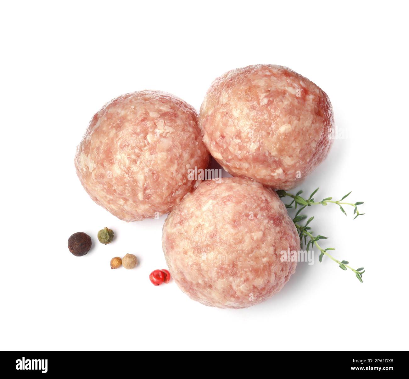 Three fresh raw meatballs with thyme and spices on white background ...