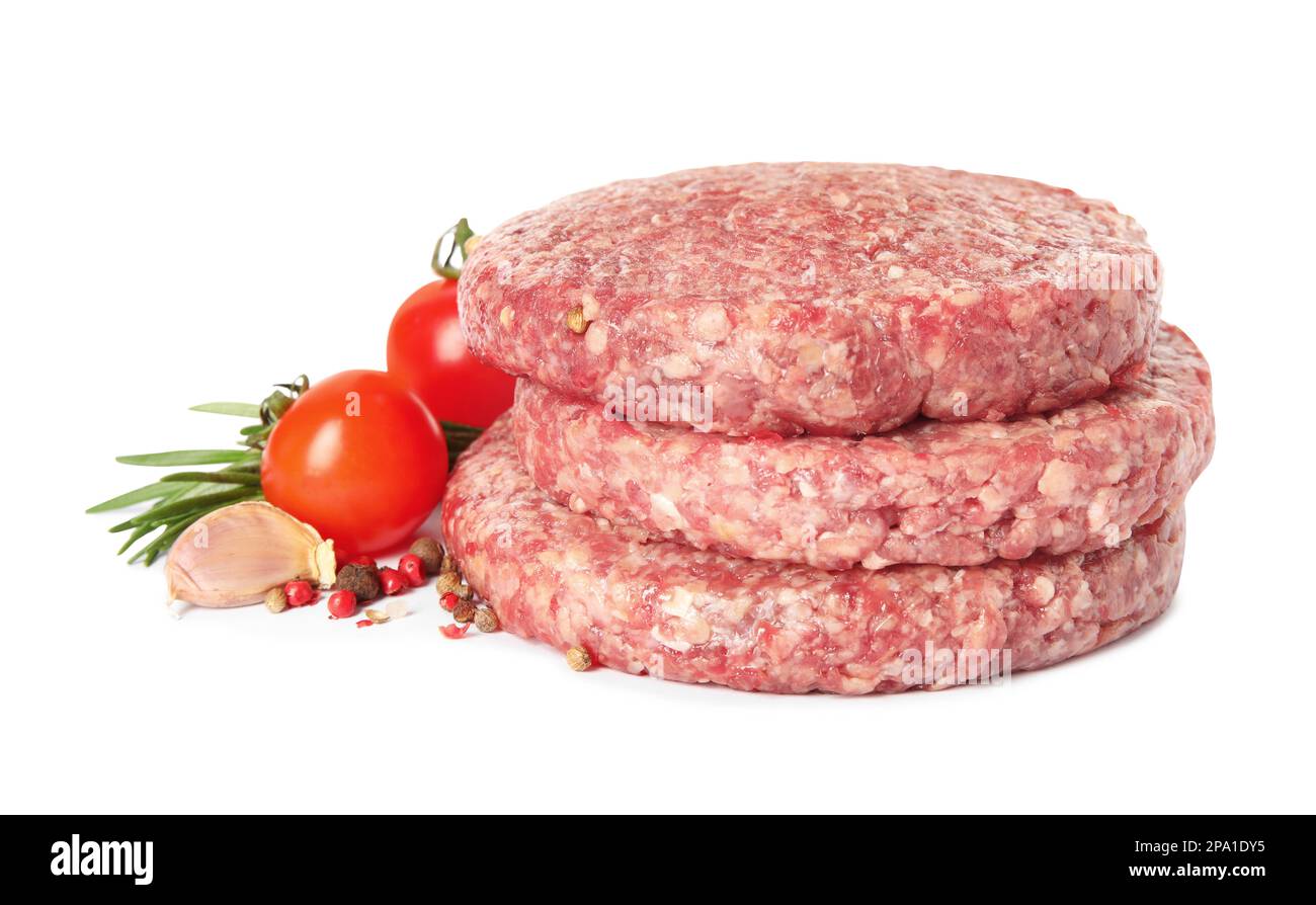 Raw hamburger patties with rosemary, vegetables and pepper on white ...