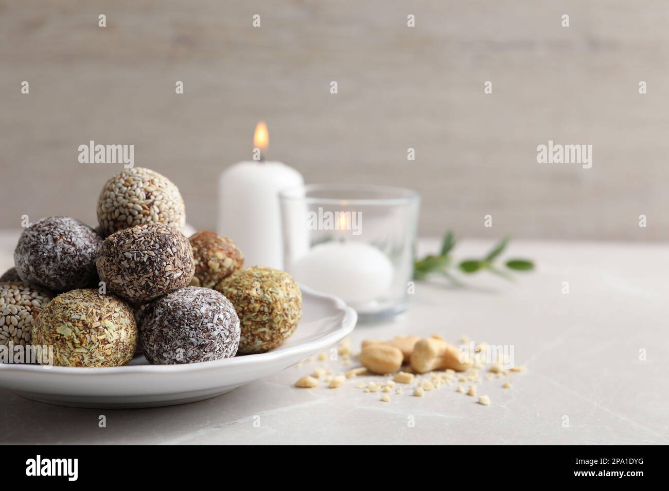 Different delicious vegan candy balls on light grey marble table. Space ...