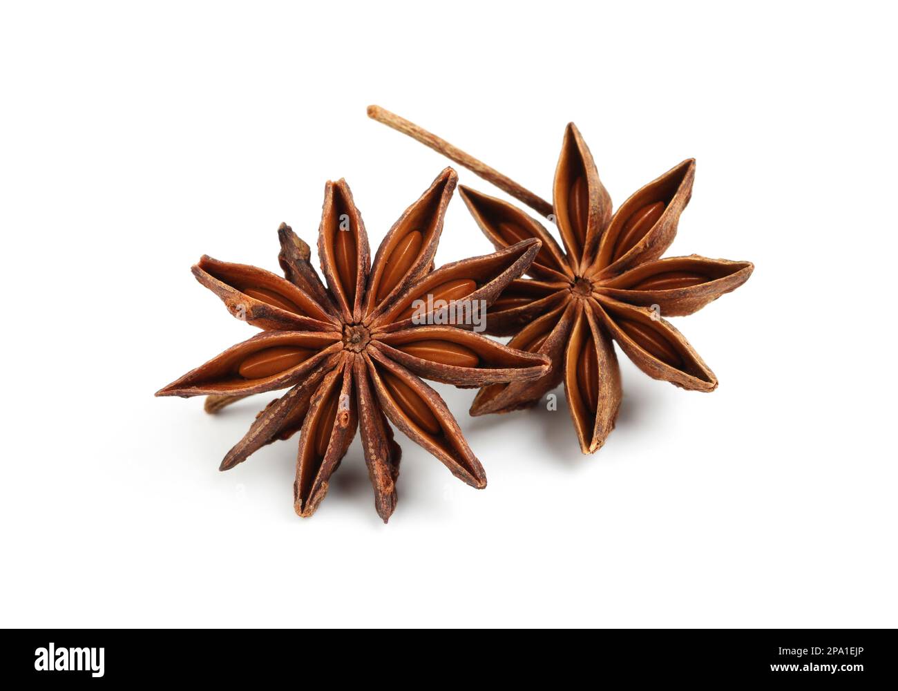 Dry anise stars with seeds on white background Stock Photo - Alamy