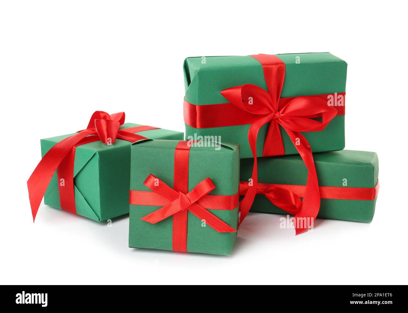 Green gift boxes with red bows on white background Stock Photo - Alamy