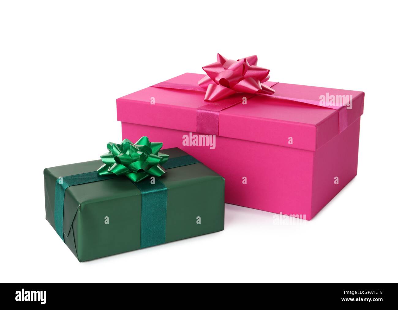 Pink and green gift boxes with bows on white background Stock Photo - Alamy