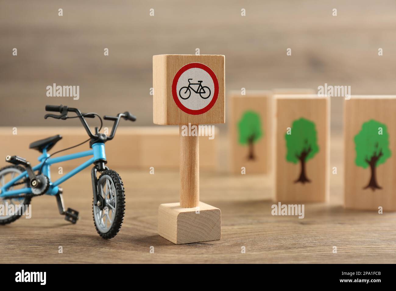 Traffic sign No cycling and toy bicycle on wooden table. Passing ...