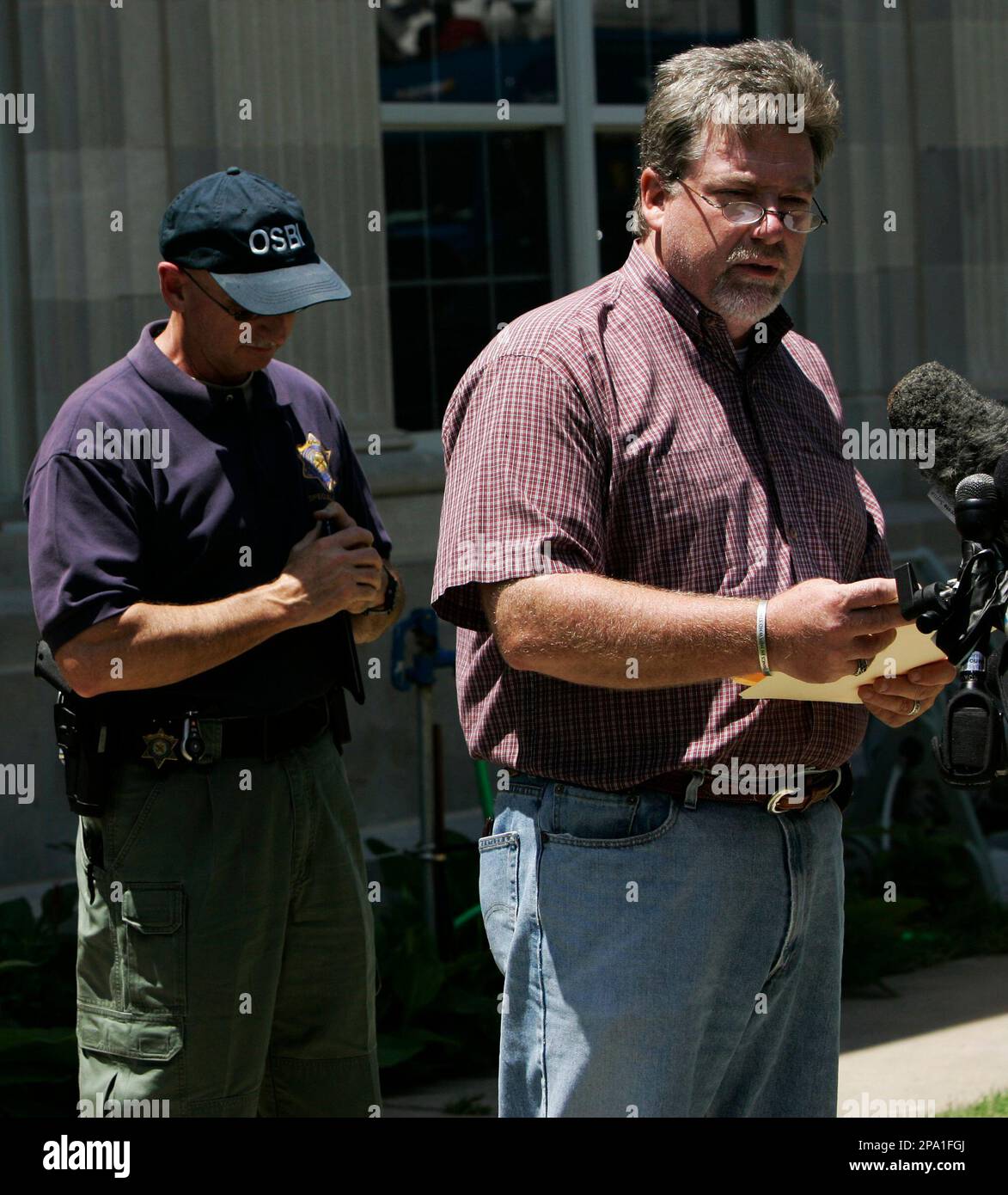 Special Agent Ben Rosser, left, of the Oklahoma State Bureau of ...