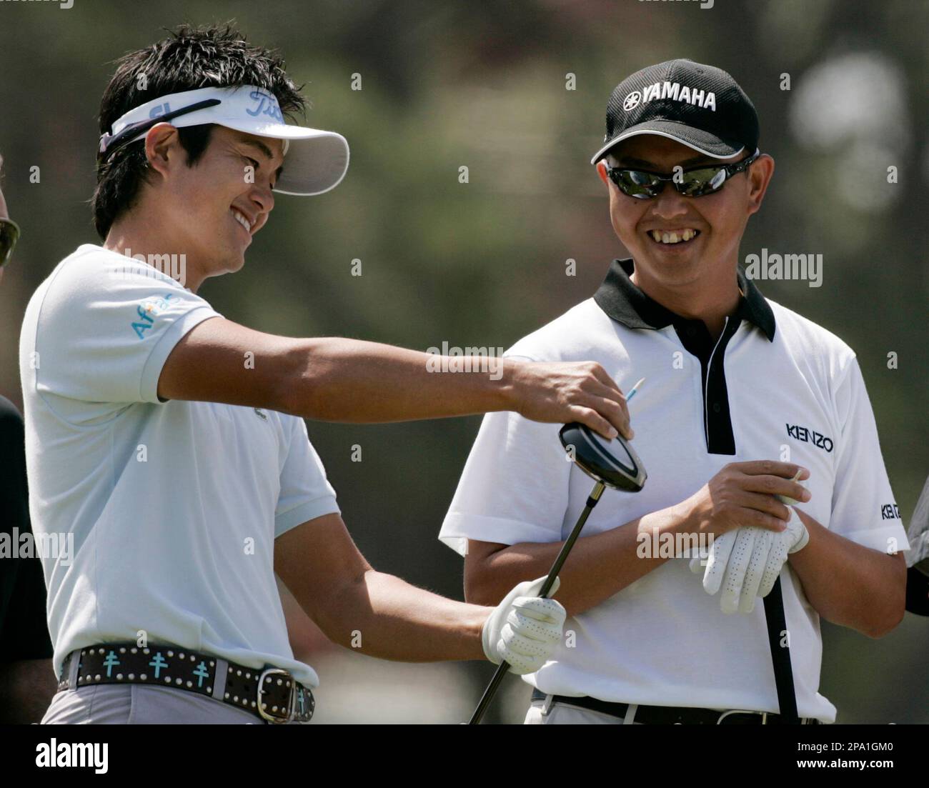 Ryuji Imada, left, of Japan and Toru Taniguchi chat on the 15th tee box ...