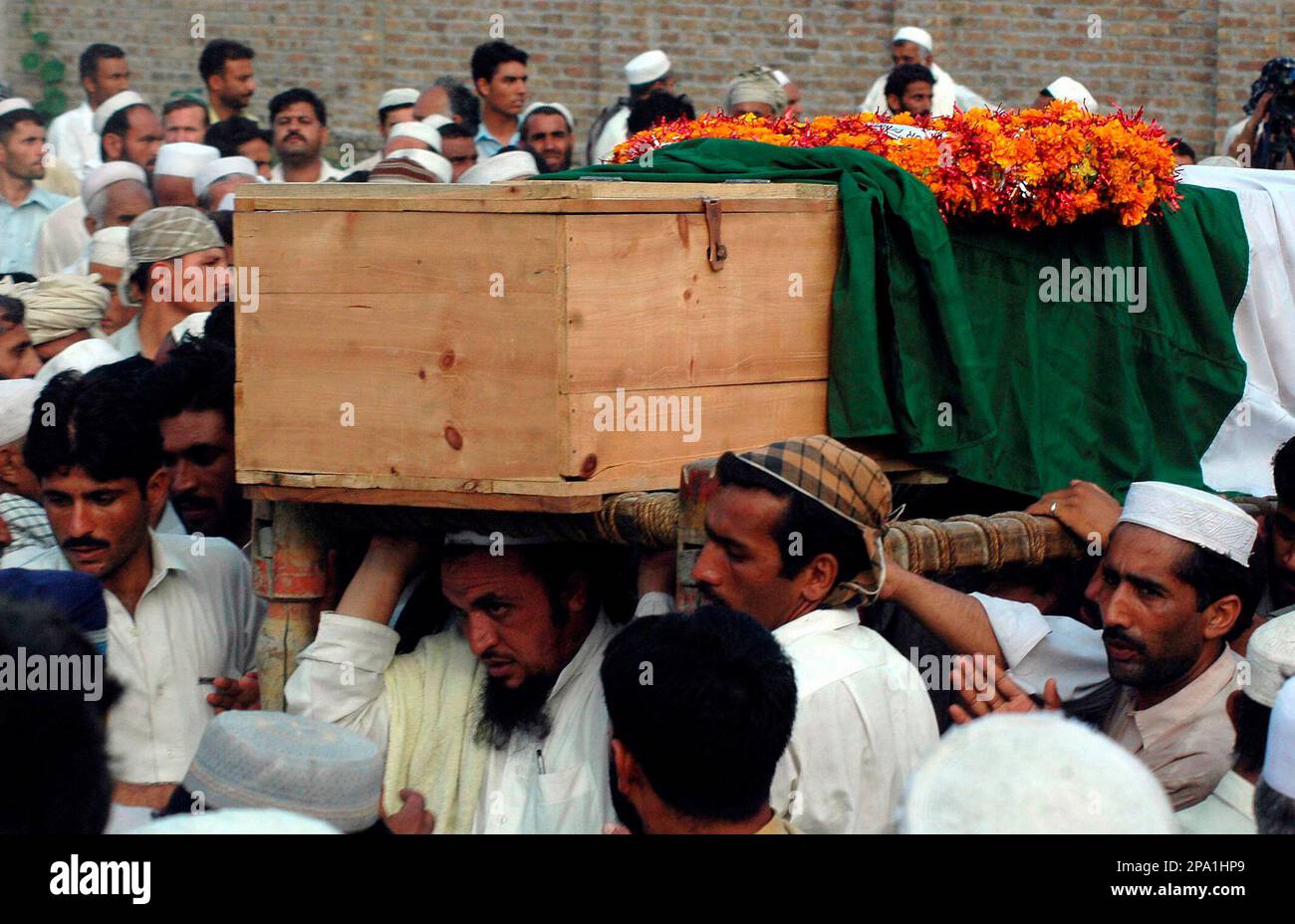 Pakistani villagers carry a coffin of Pakistan's paramilitary soldier ...