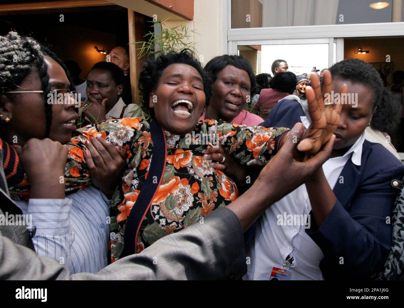 A unidentified relative cries as the bodies of Kenyan Roads Minister ...