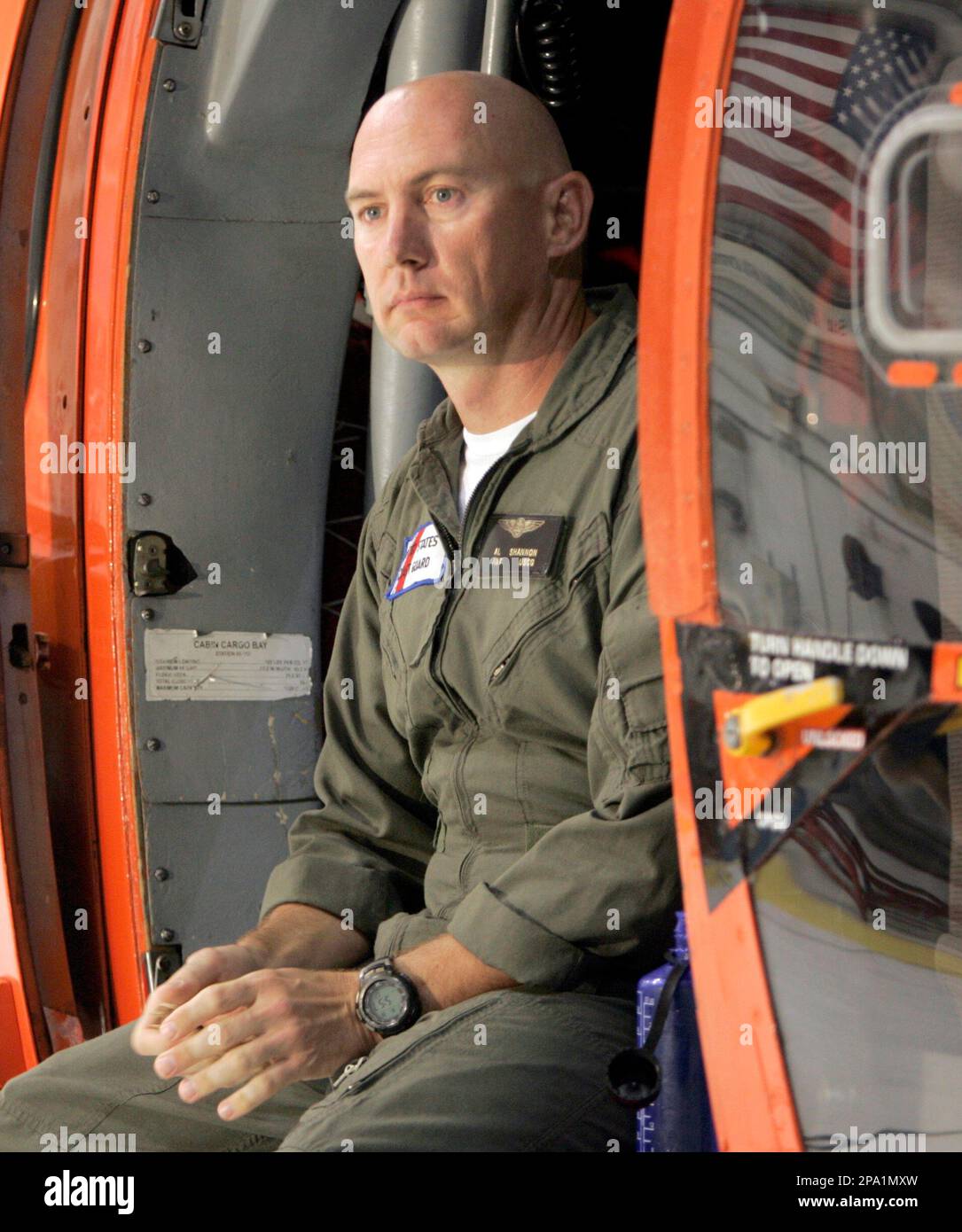 U.S. Coast Guard Chief Al Shannon rests in a rescue helicopter at the ...