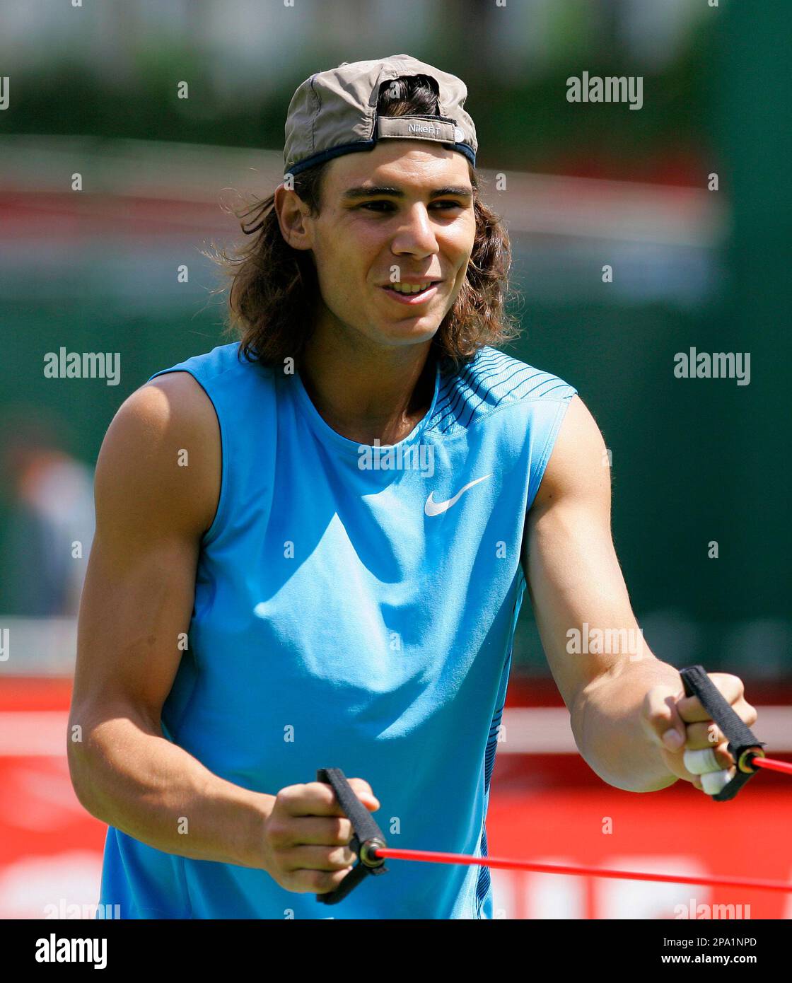 Spain's Rafael Nadal smiles as he stretches during a training session ...