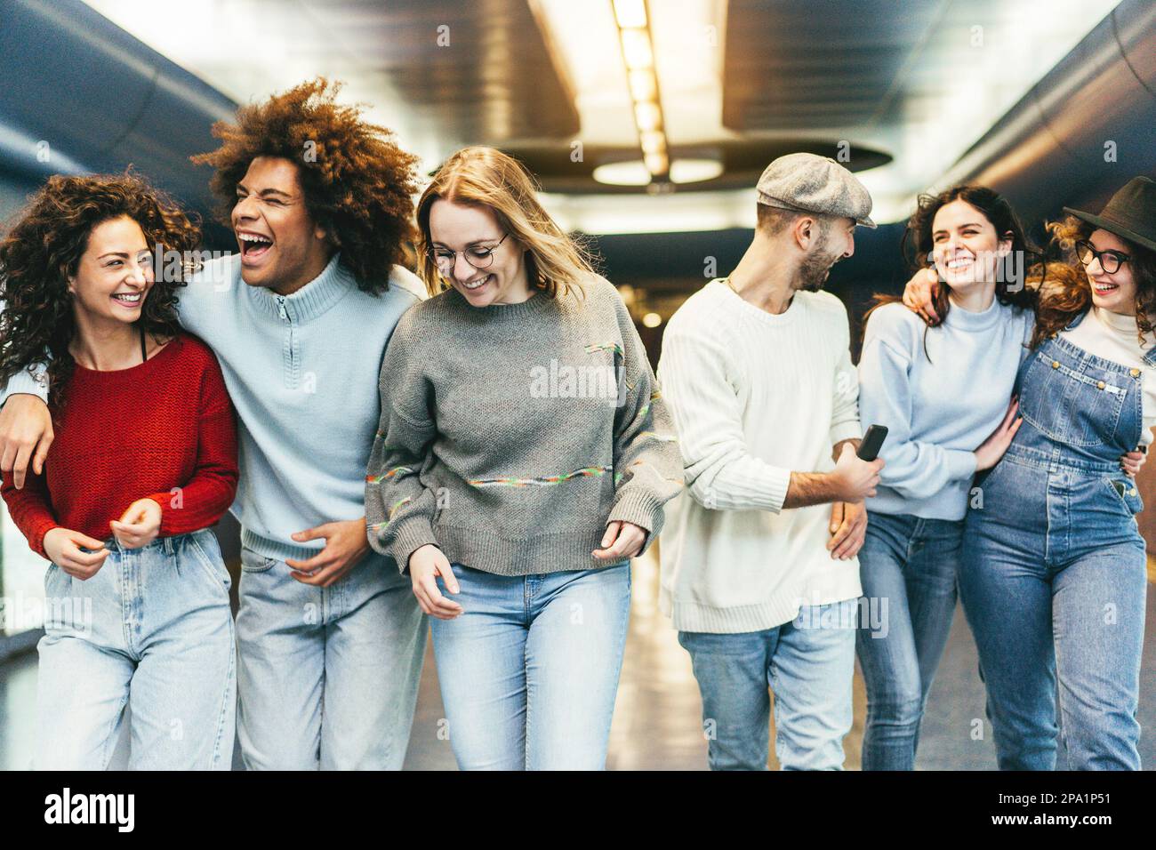 Happy friends having fun inside underground metropolitan station - Soft ...