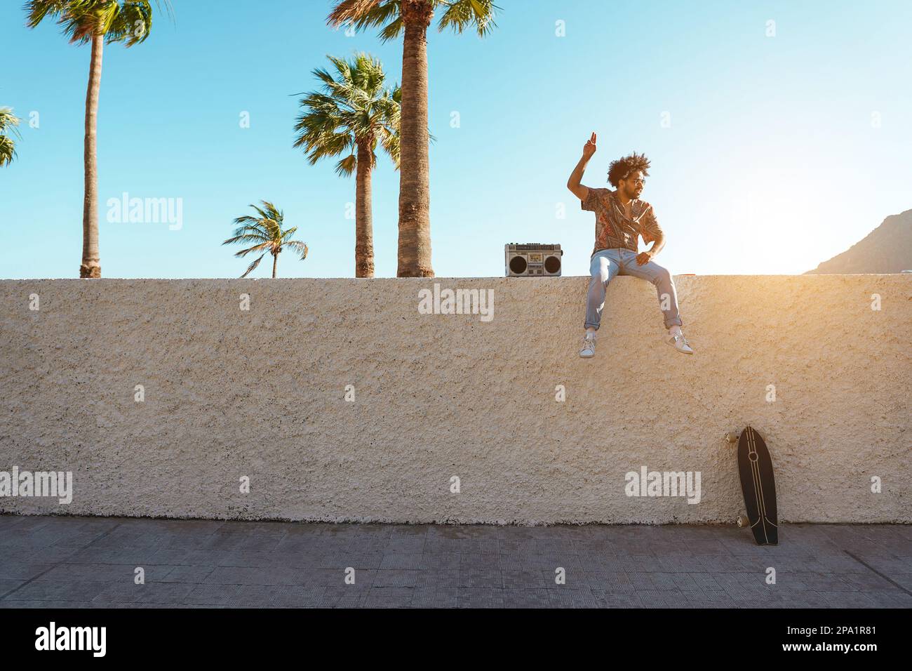 African american man listening and dancing to music outdoor - Focus on ...