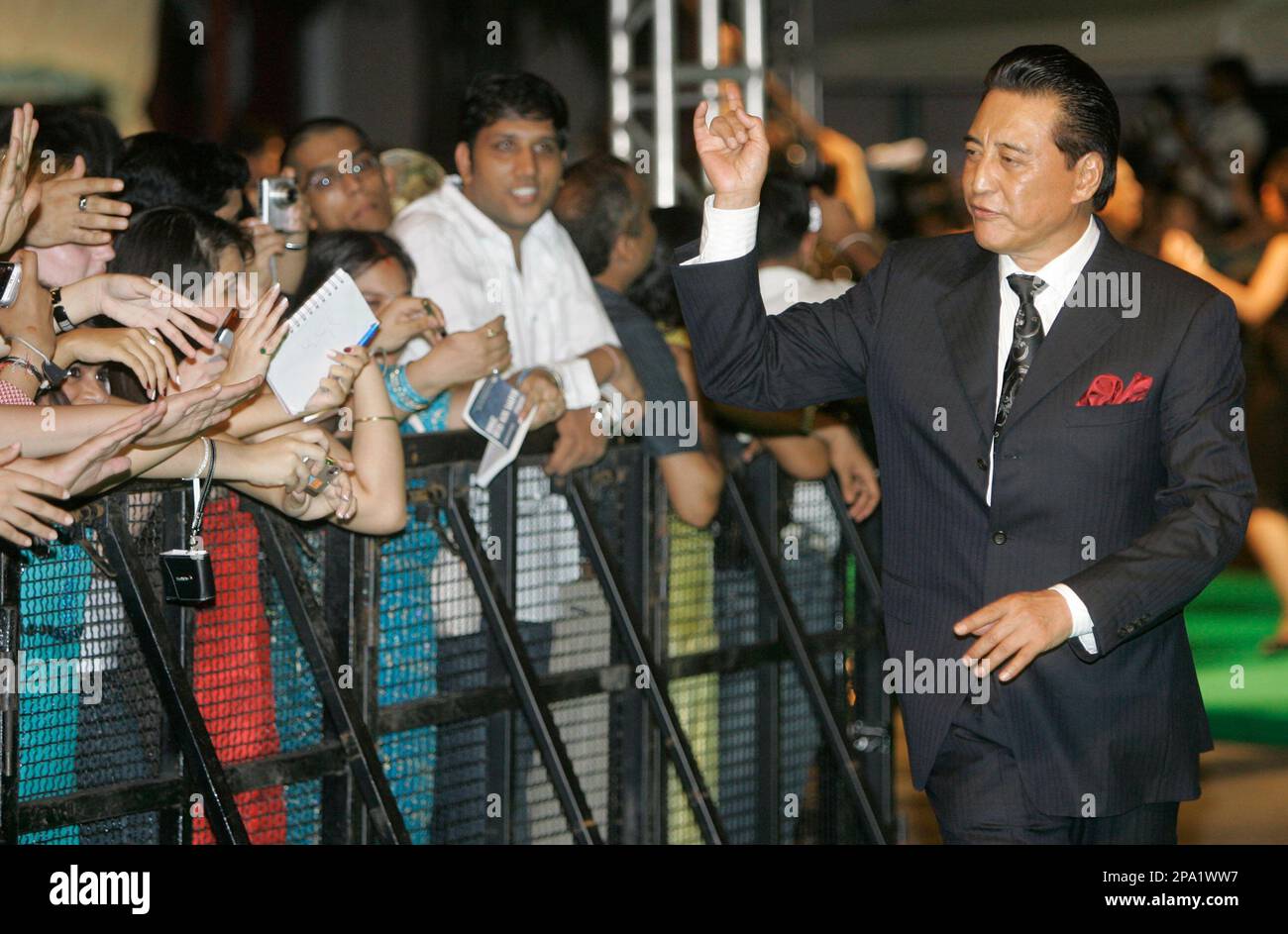 Bollywood actor Danny Denzongpa, right, talks with fans as he arrives ...