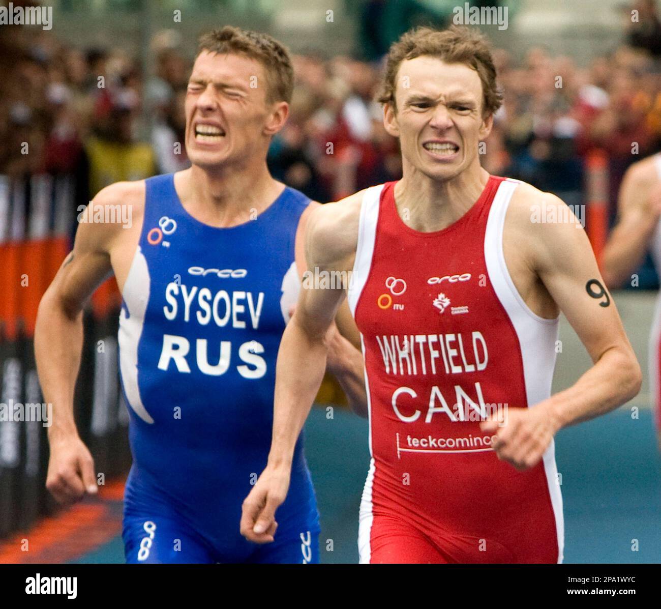 Canada's Simon Whitfield, right, races Igor Sysoev of Russia to the finish line during the Elite ...
