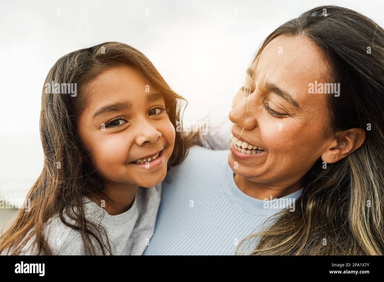 Happy latin mother and daughter having fun together outdoor - Focus on ...