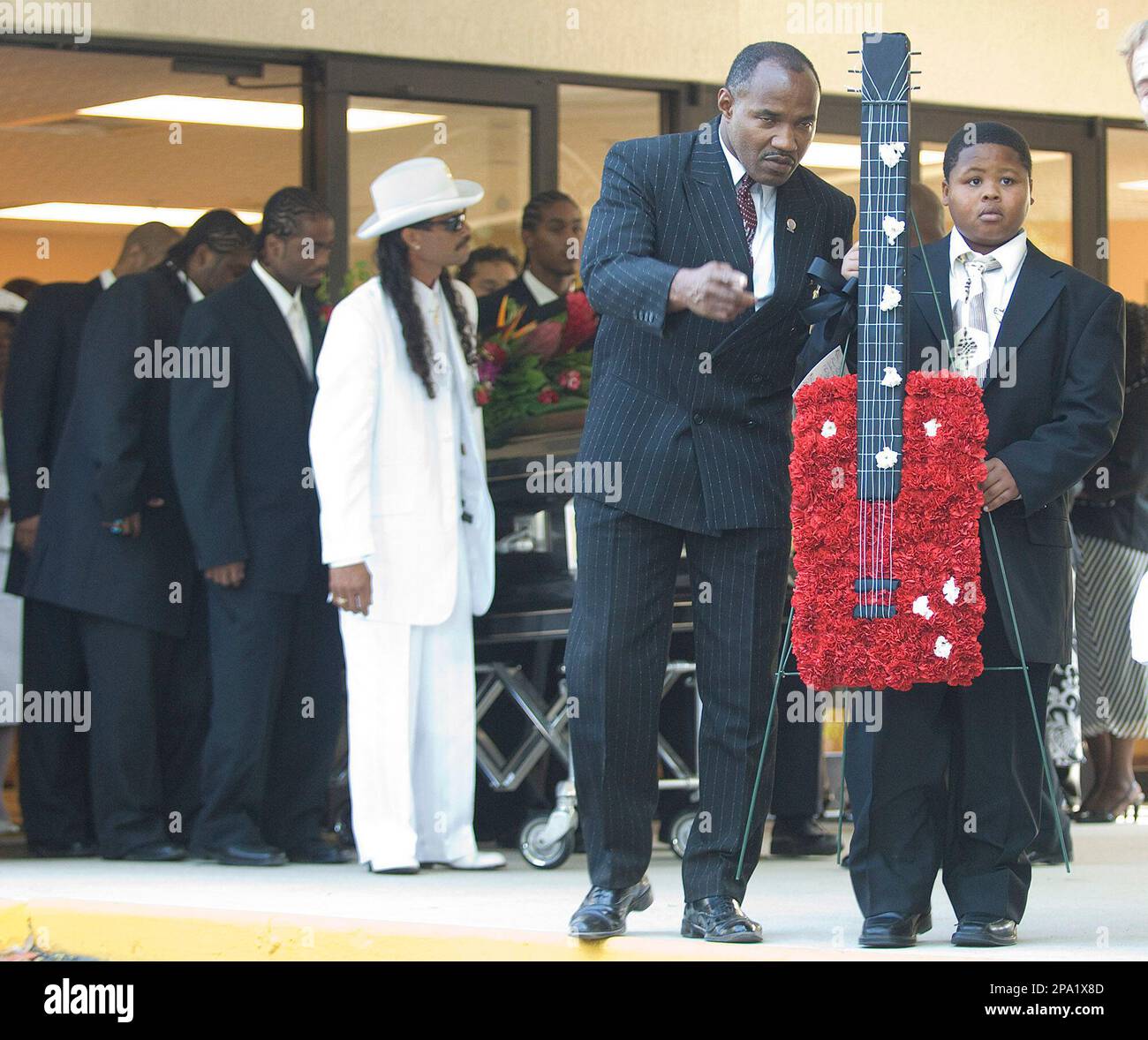 Bo Diddley's great grandson Tarik McDaniel carries a floral wreath ...