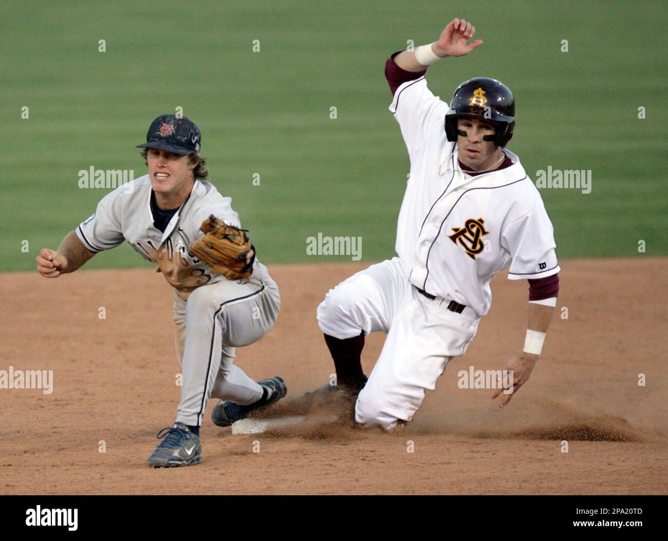 Fresno State second baseman Erik Wetzel, left, makes the catch but not ...