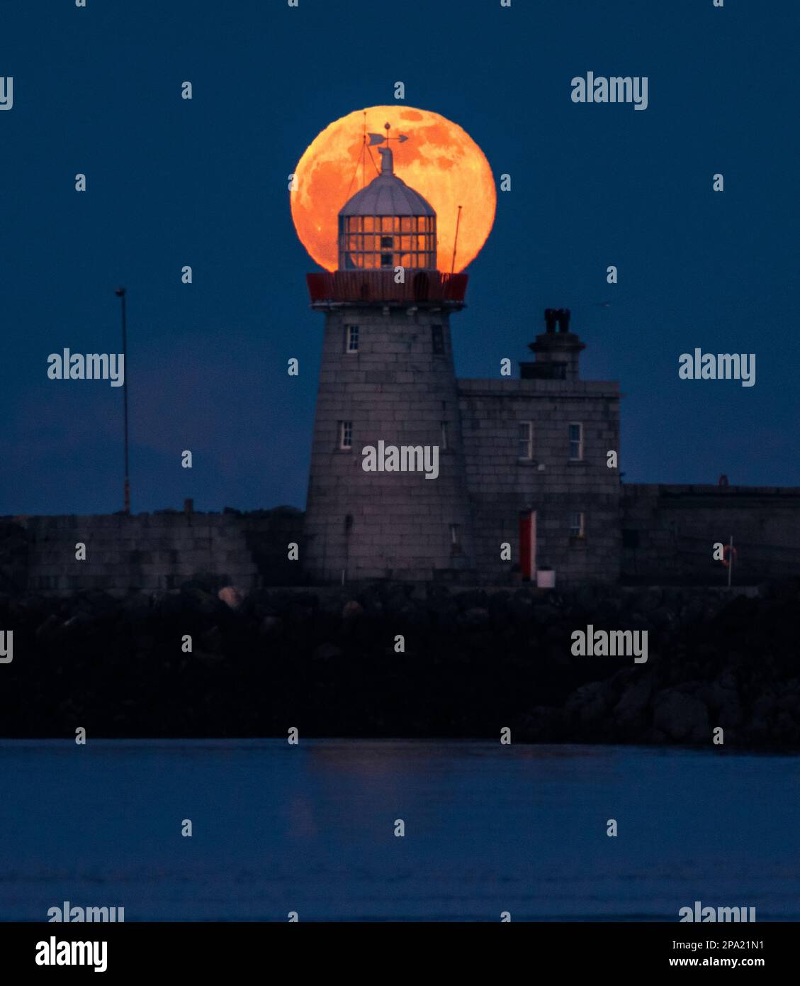 The full Worm Moon rising behind Howth Lighthouse Stock Photo - Alamy