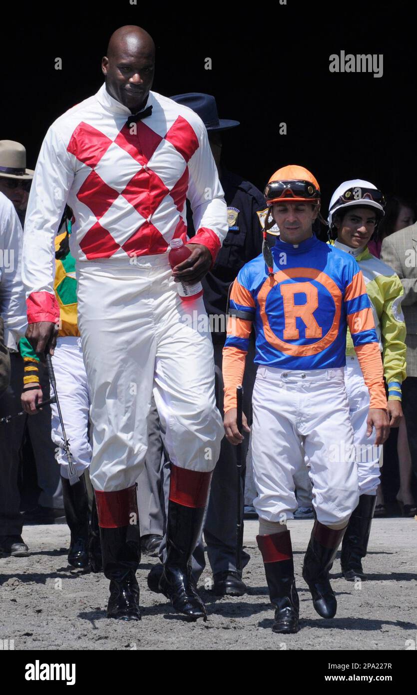 Dressed in jockey silks, Phoenix Suns' Shaqnille O'Neal, left, walks ...