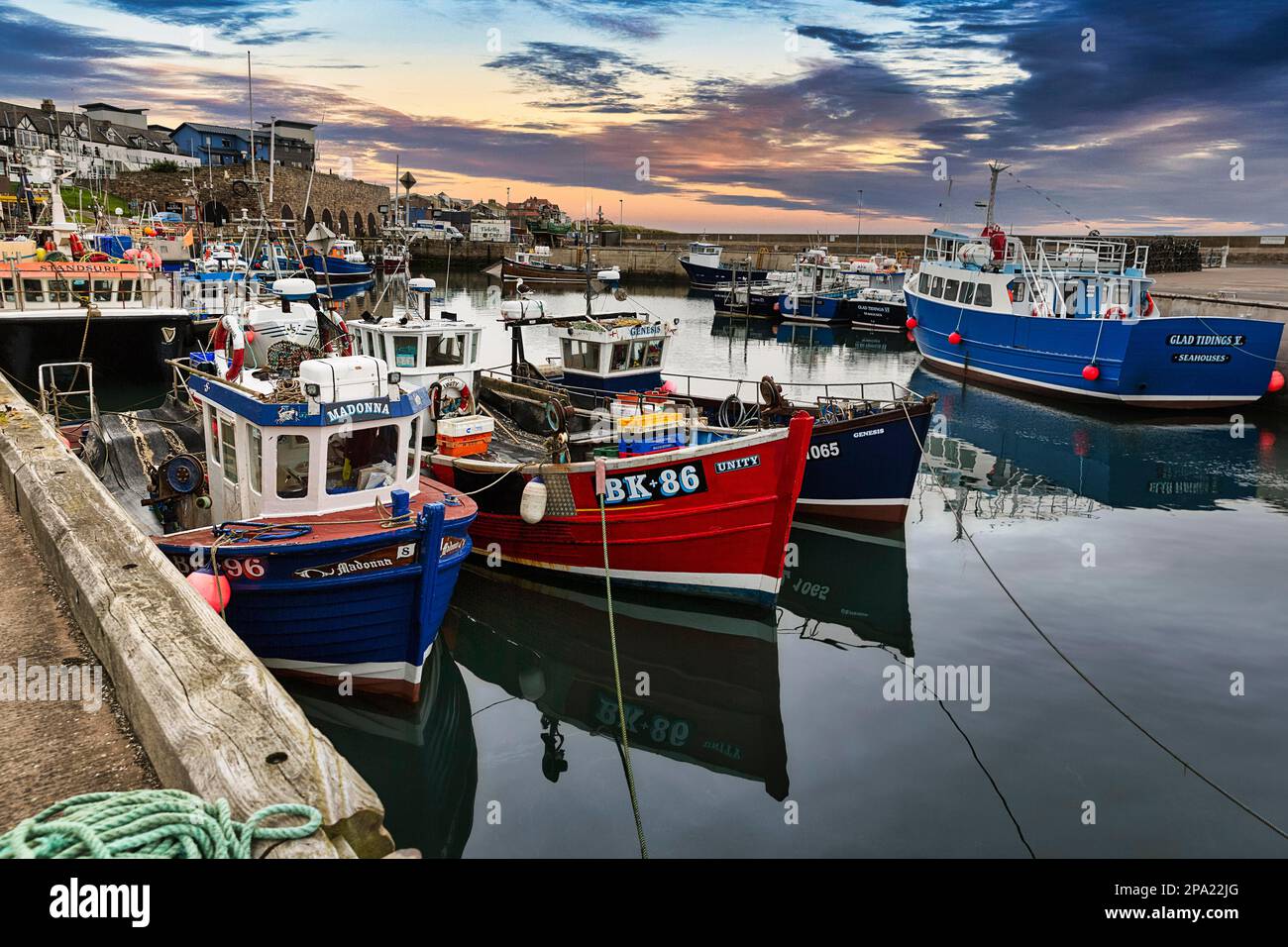 Fishing boats in the harbour, evening sky, Seahouses fishing village ...