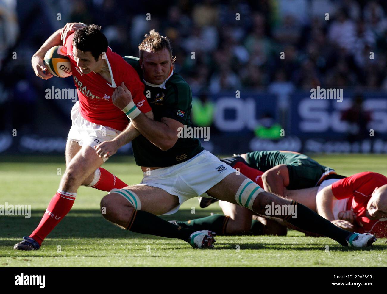 Wales rugby player Stephen Jones, left, is tackled by South Africa's ...